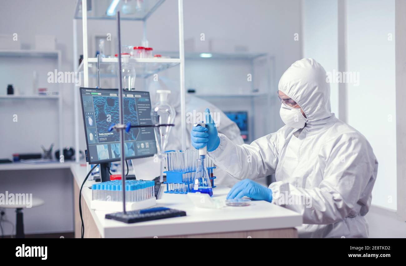Researcher scientist working with micropipette in big scientific lab ...