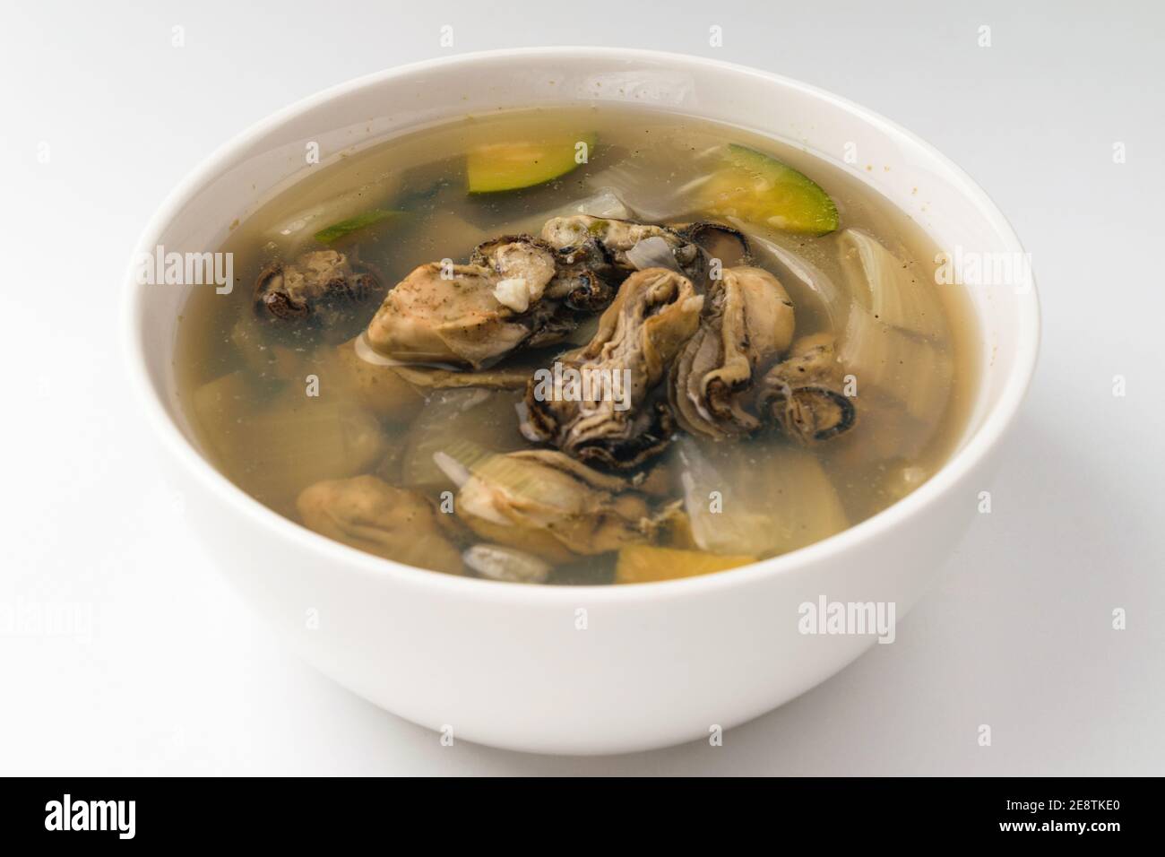 Oyster soup on white background Stock Photo - Alamy