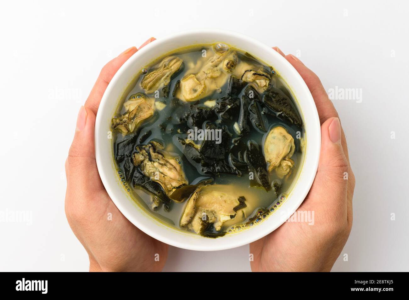 Oyster seaweed soup on white background Stock Photo - Alamy