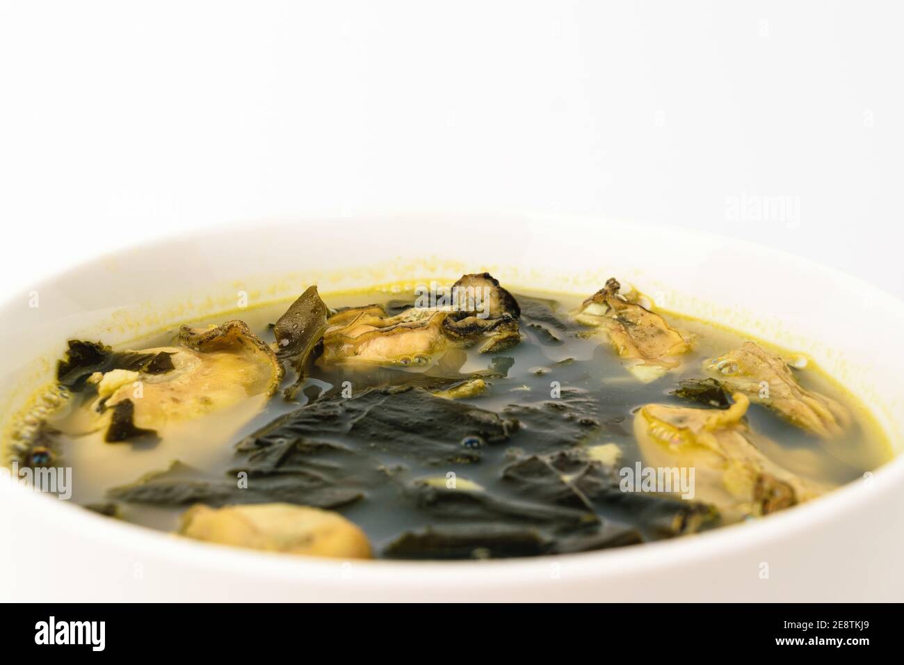 Oyster seaweed soup on white background Stock Photo - Alamy