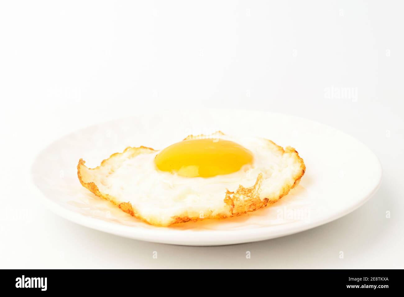 Fried eggs on white background Stock Photo - Alamy