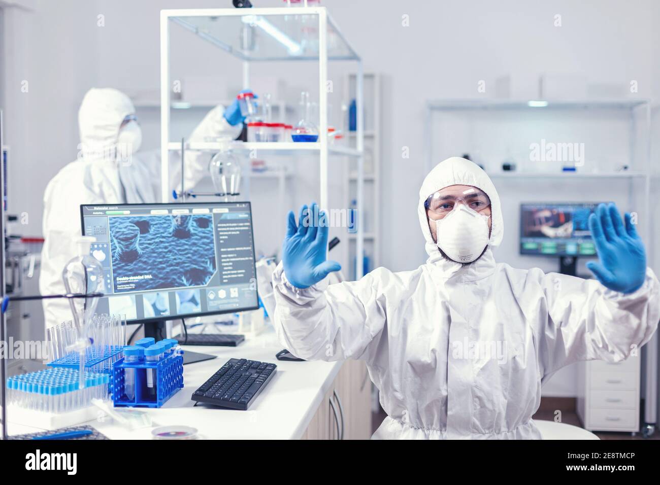 Healthcare engineer in laboratory looking at digital screen holding ...