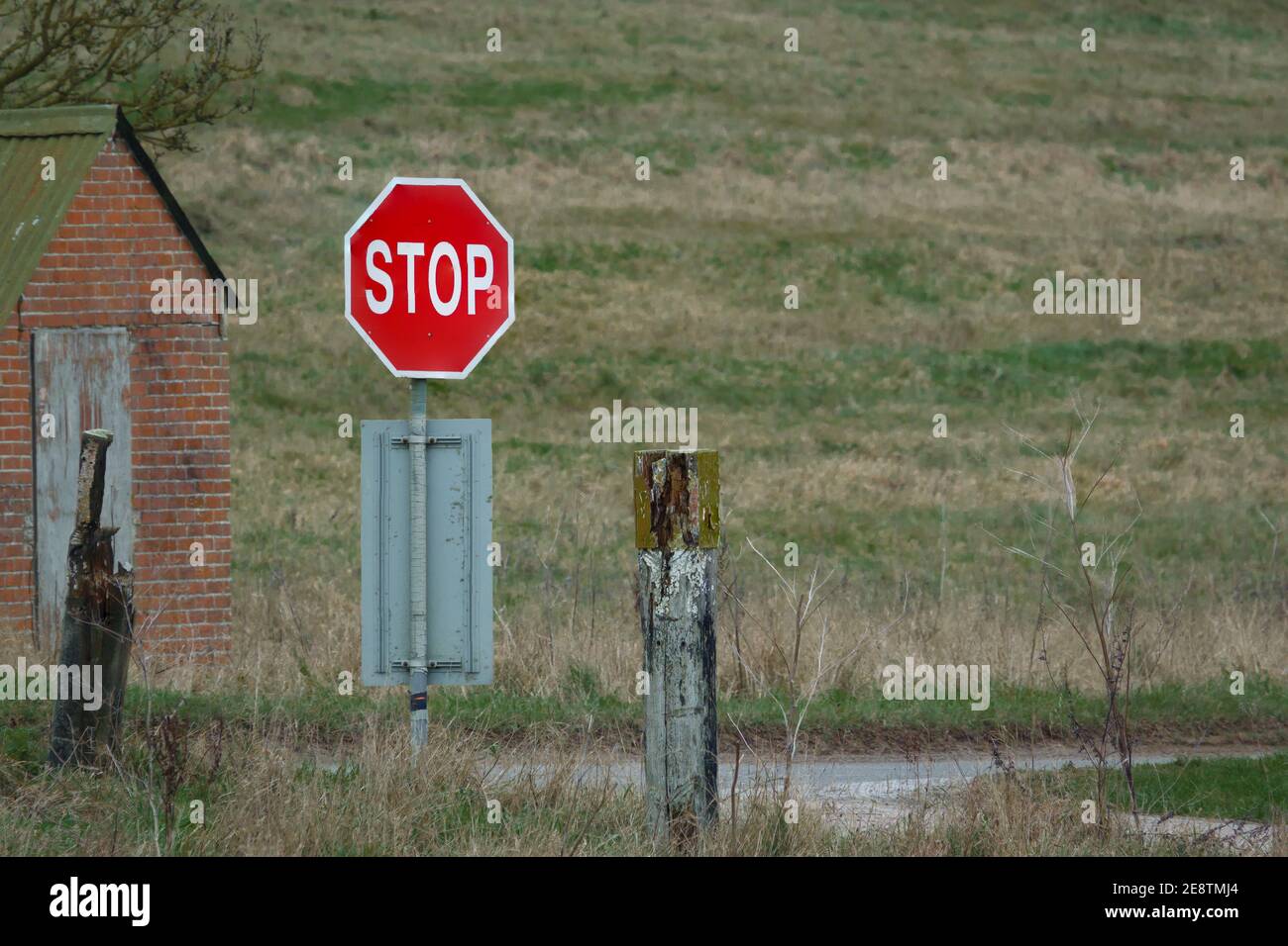 bright red Stop sign at a tank crossing and road junction on Salisbury ...