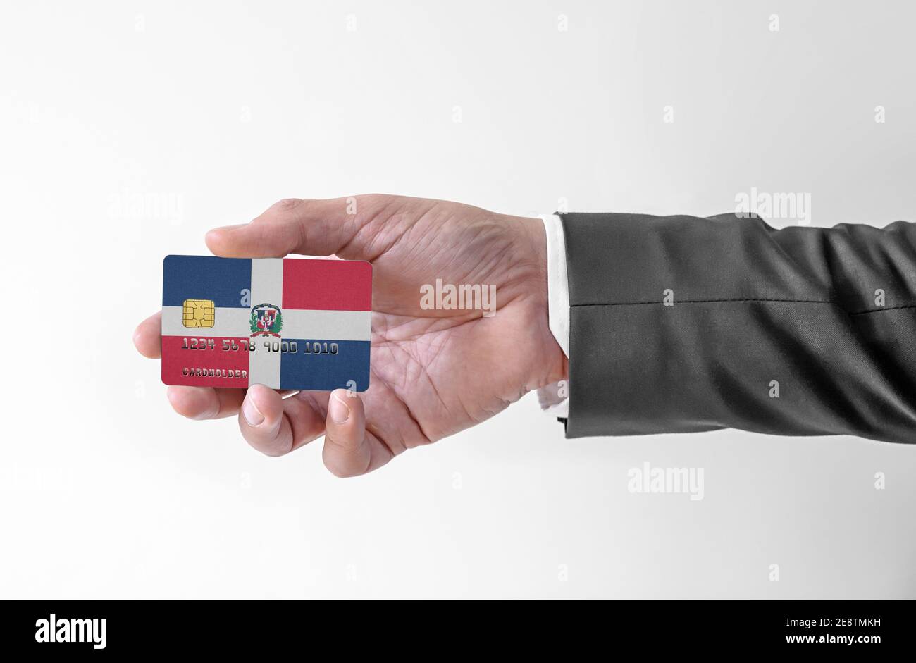 Bank credit plastic card with flag of Dominican Republic holding man in ...