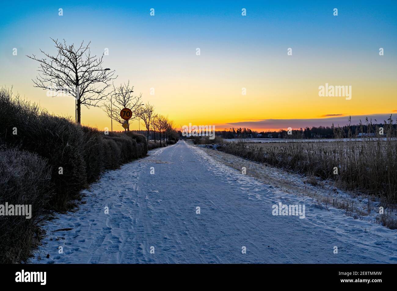 sunrise over cycle path covered in snow Stock Photo - Alamy