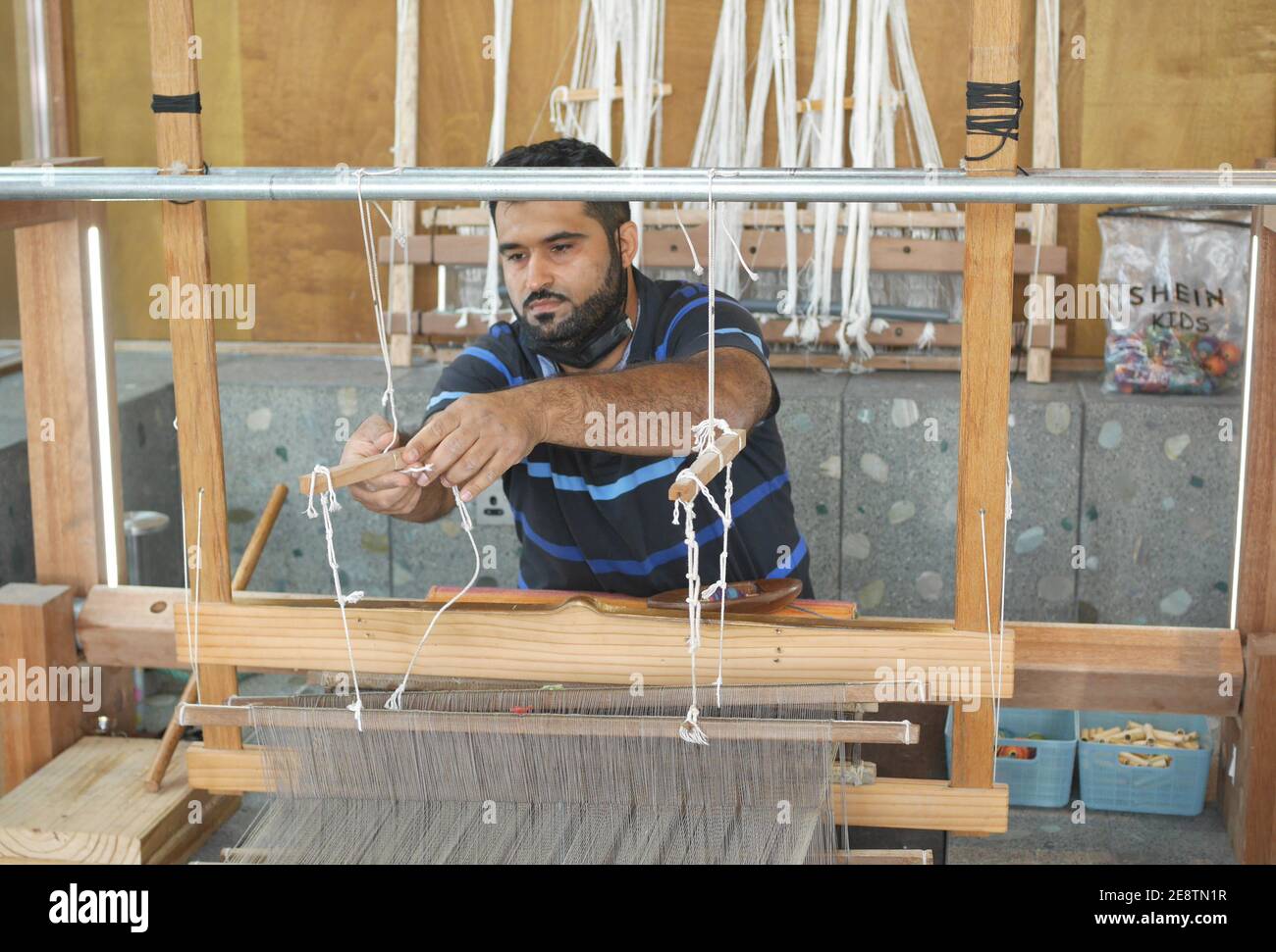 Traditional Bahraini textile weaver at his loom, Bani Jamra textile ...