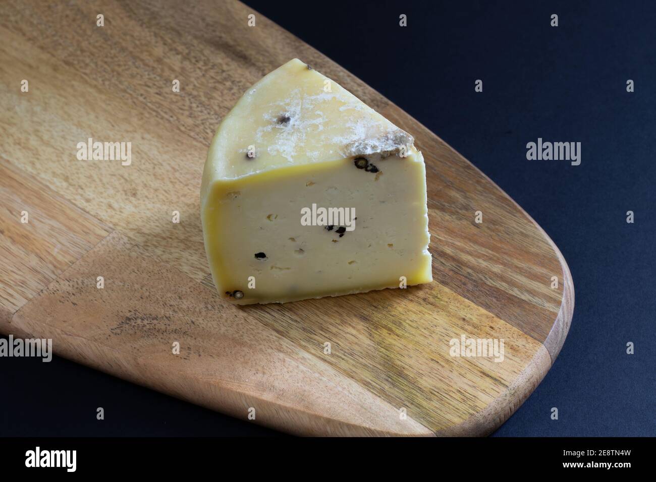 Cheese with pepper, a triangular piece of natural cheese made from farm ...