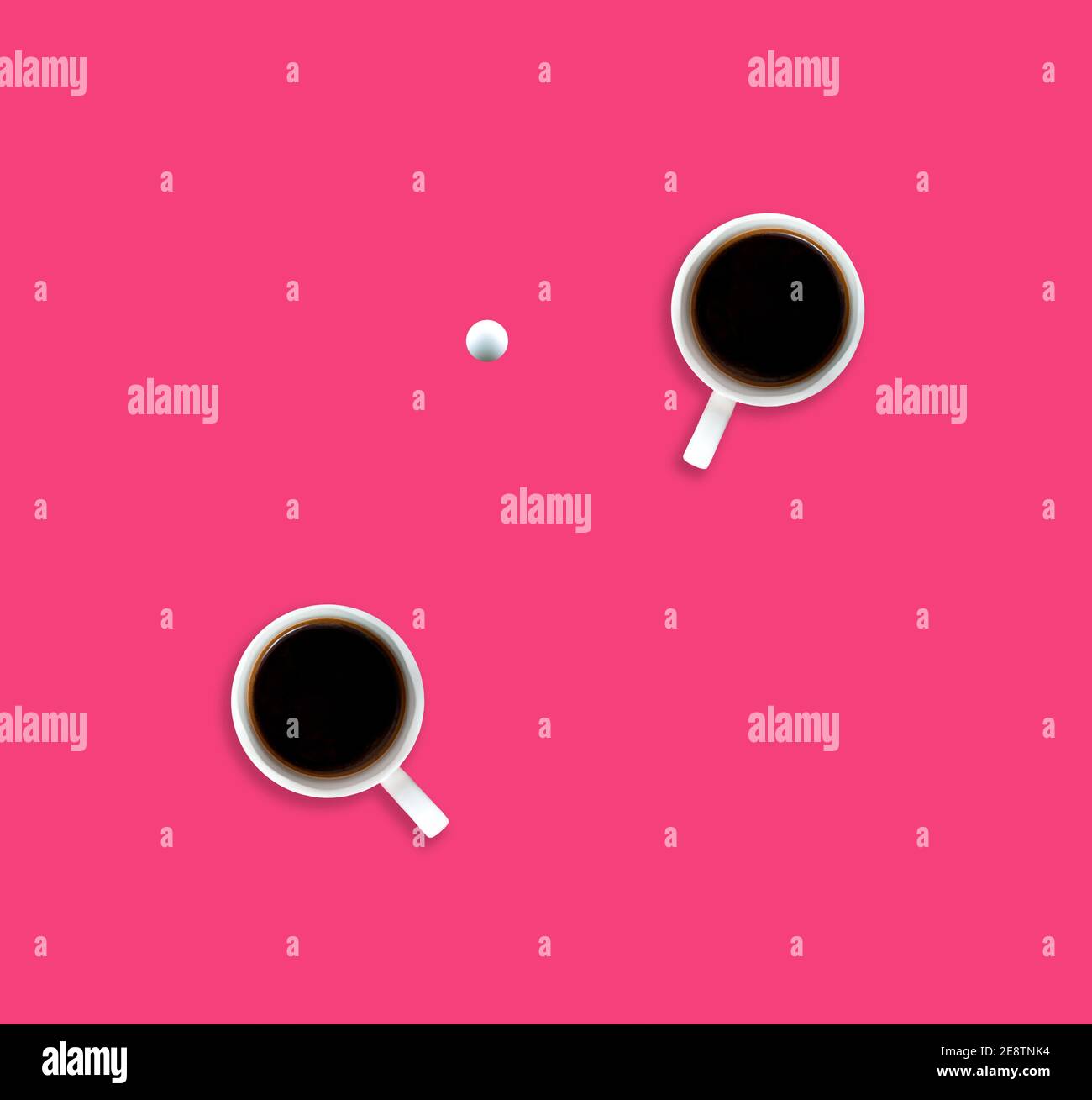Flat lay of two coffee cups and a tennis ball on pink background Stock ...