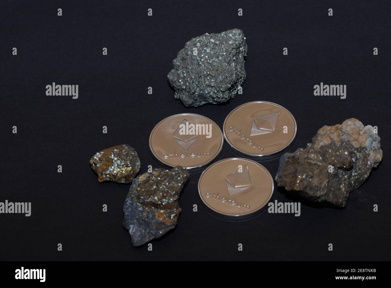 three silver ether coins from cryptocurrency and minerals with iron on ...
