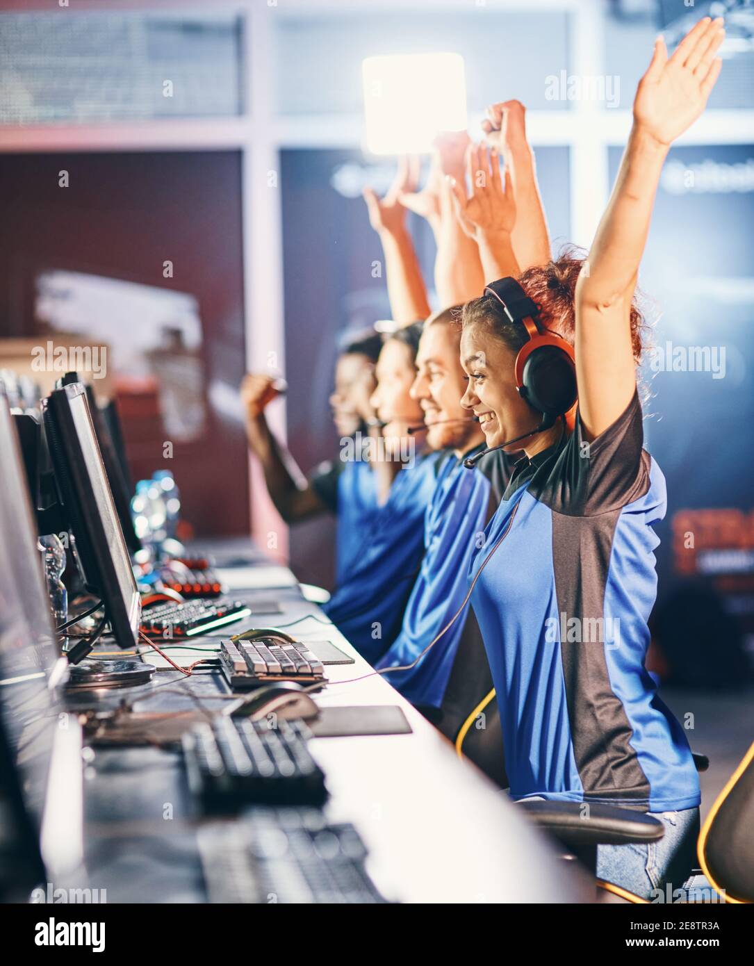 Winning. Young multiracial team of happy professional cyber sport ...