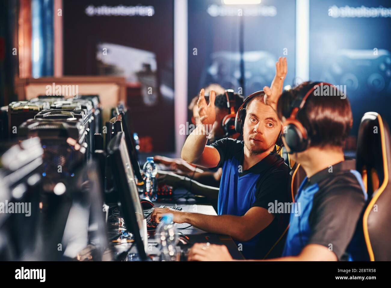 We are winning. Two happy male cyber sport gamers giving high five to ...