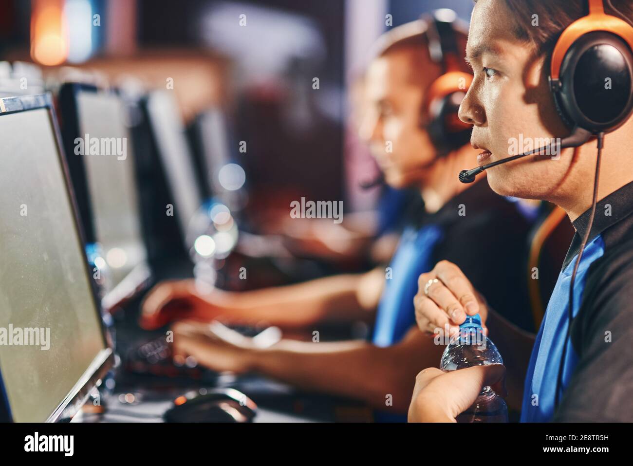 Video games online competition. Side view of shocked young asian guy ...