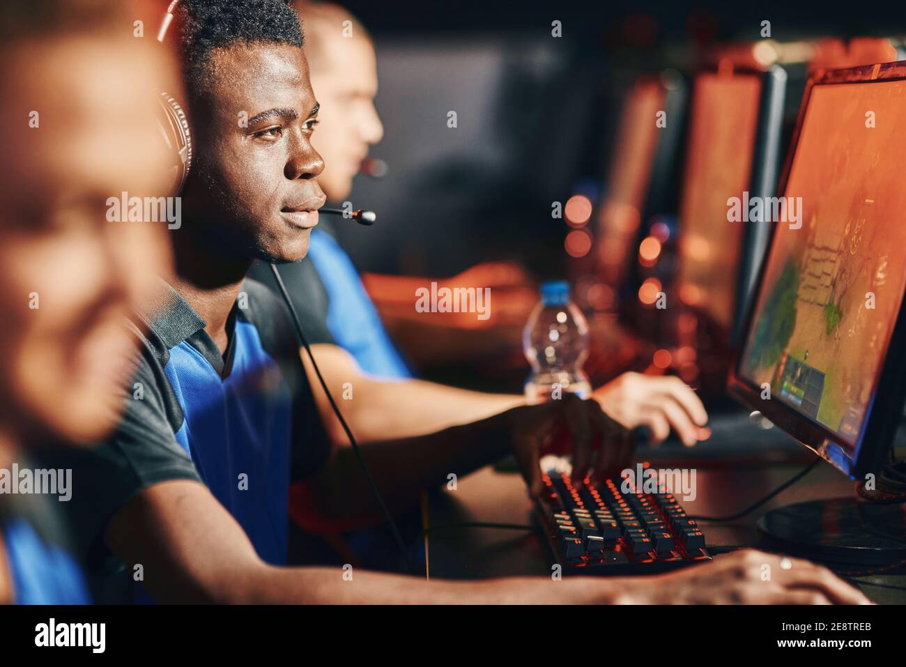 Young african guy, professional cybersport gamer wearing headphones ...