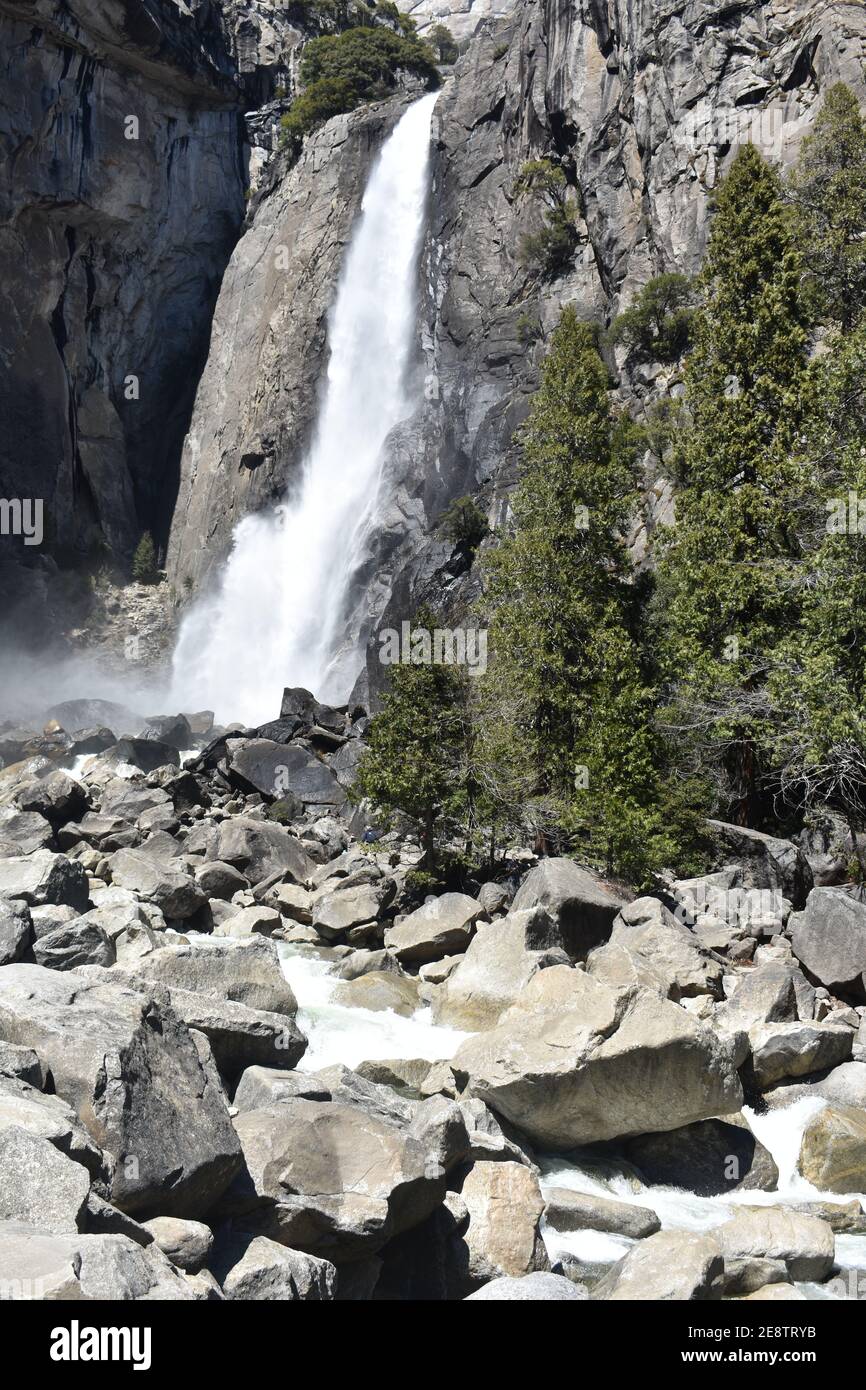 Vertical view of a massive granite wall with a waterfall in Yosemite ...