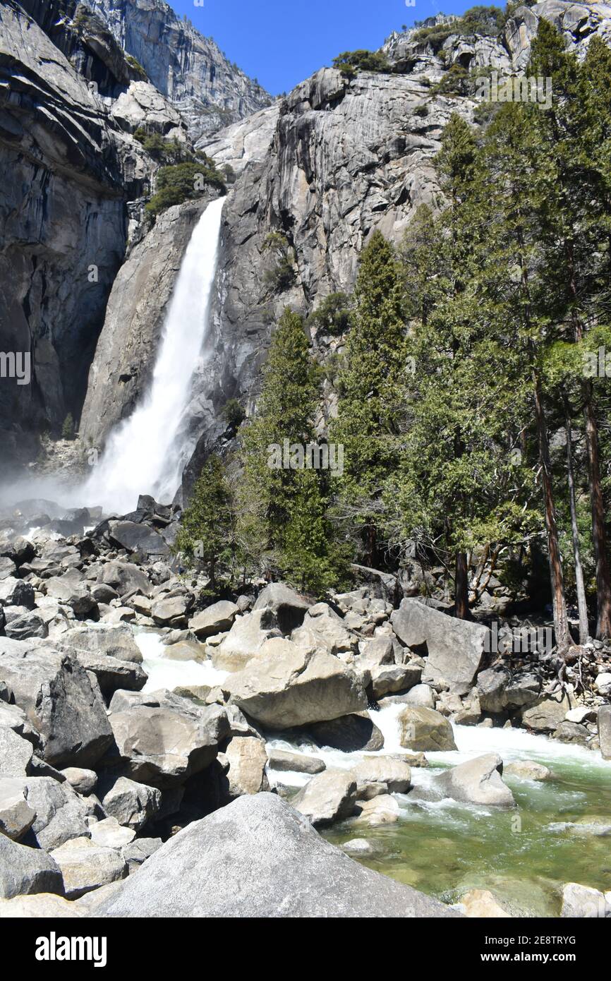 Vertical view of a massive granite wall with a waterfall in Yosemite ...