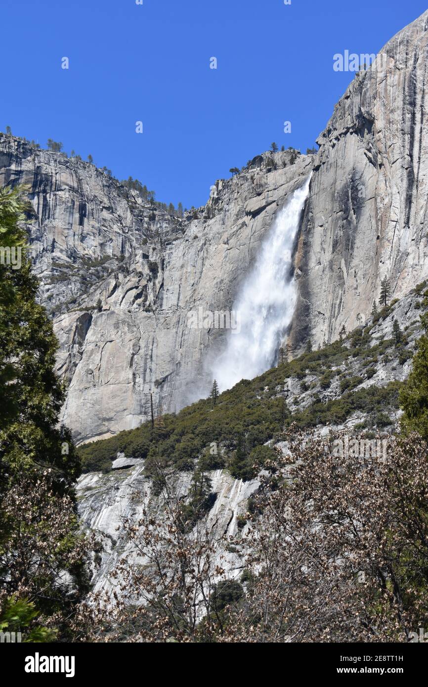 Vertical view of a massive granite wall with a waterfall in Yosemite ...