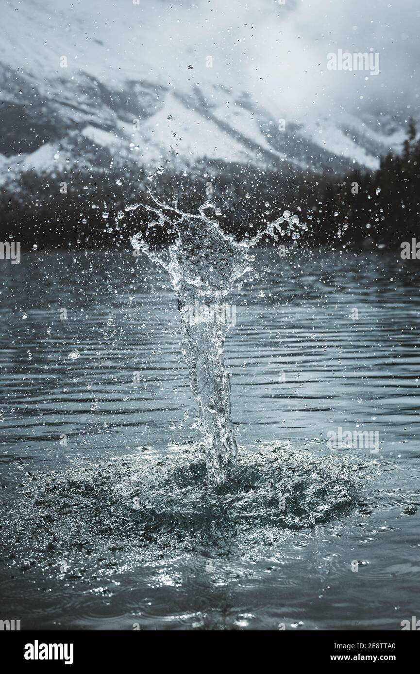 water splatter after throwing a rock into a mountain lake Stock Photo ...