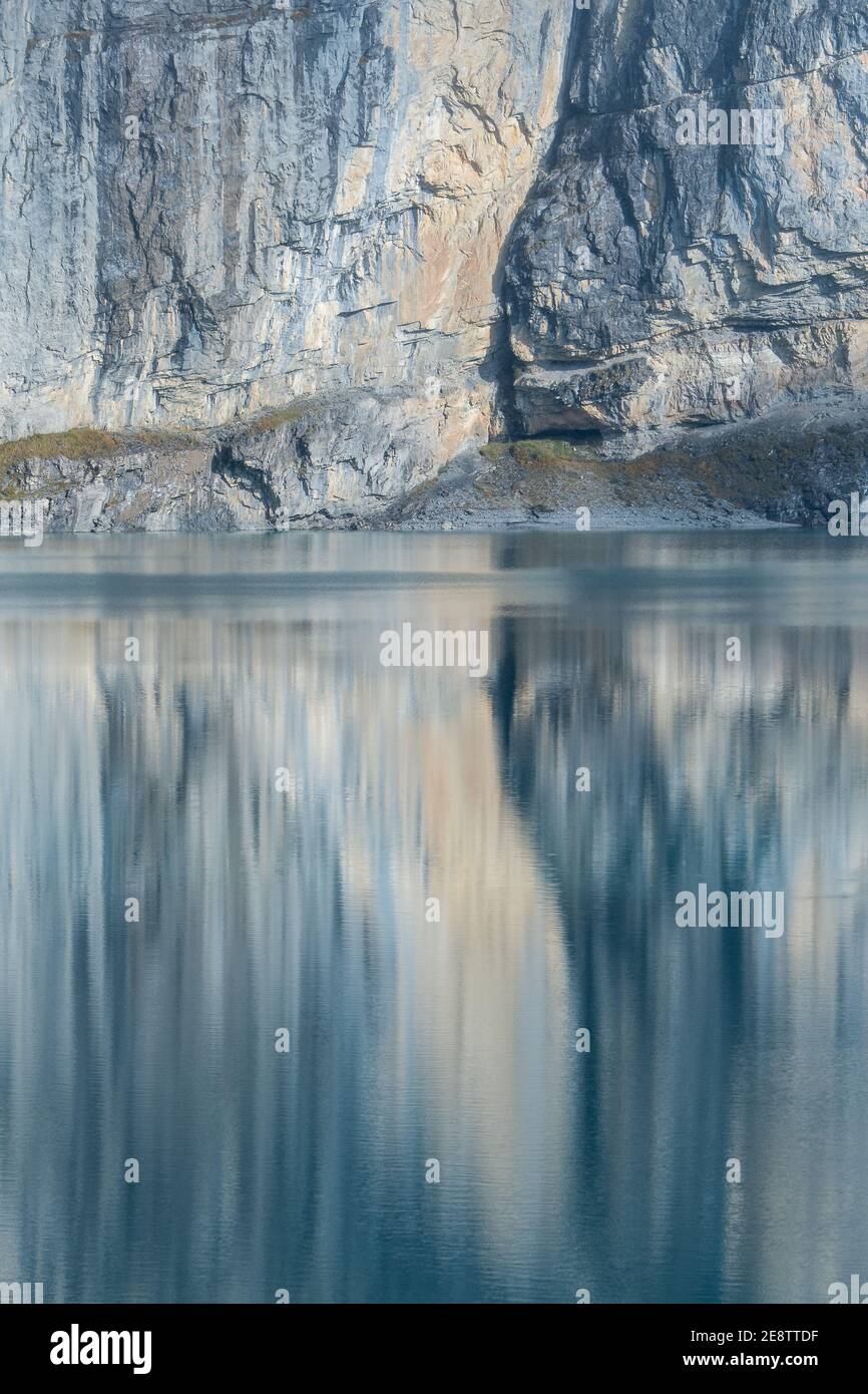 artistic reflection of a rock face in Oeschinensee Stock Photo - Alamy