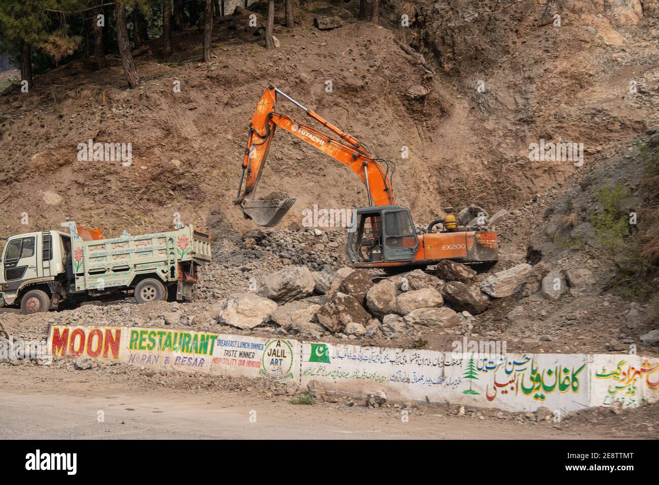 Lifter busy for the construction work on Mountain road Stock Photo - Alamy