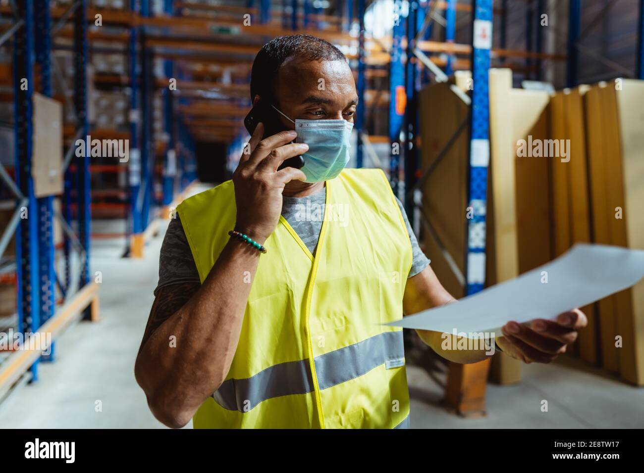 warehouse manager wearing a face mask Stock Photo - Alamy