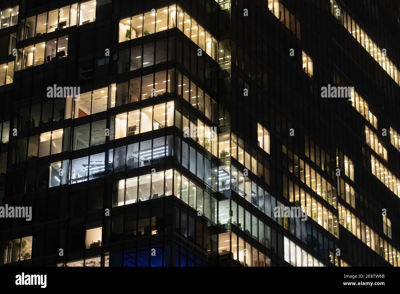 Windows of corporate skyscraper at night, office building in financial ...
