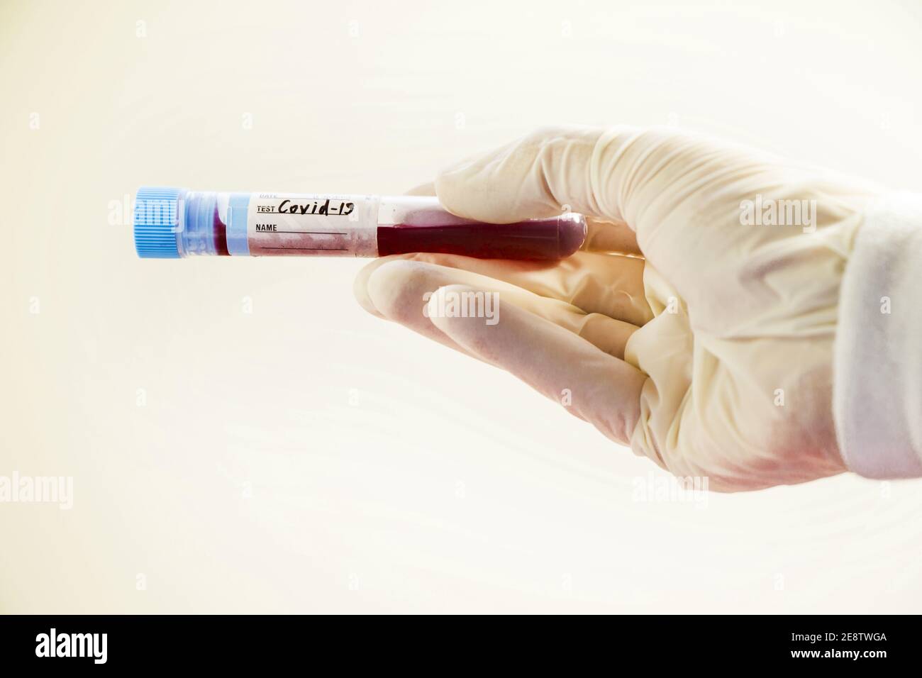 Gloved hand holding test tubes hi-res stock photography and images - Alamy