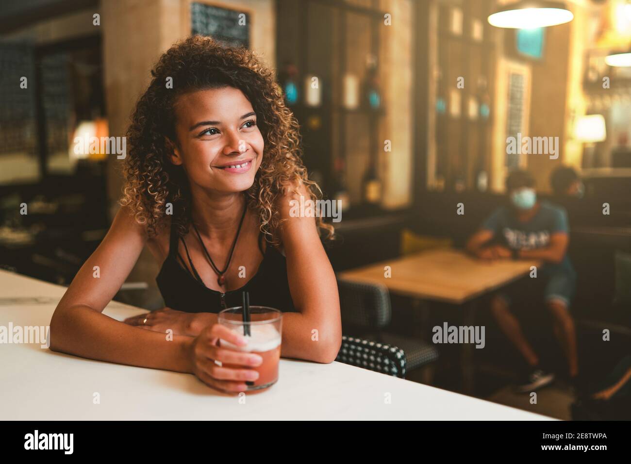Pretty woman sitting alone at bar hi-res stock photography and images ...