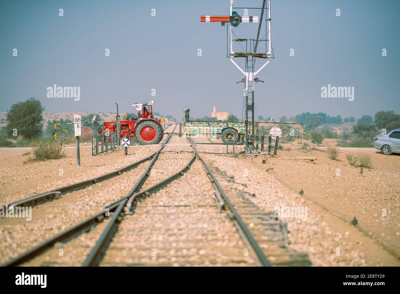 Railway tracks crossing intersection where passing tractor trolley ...