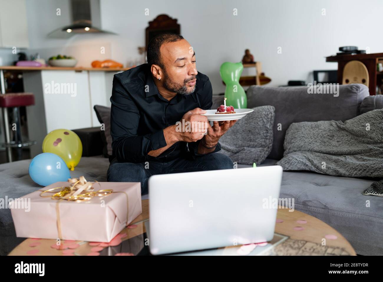 Handsome 40 years old man blowing candles on his birthday cake Stock ...