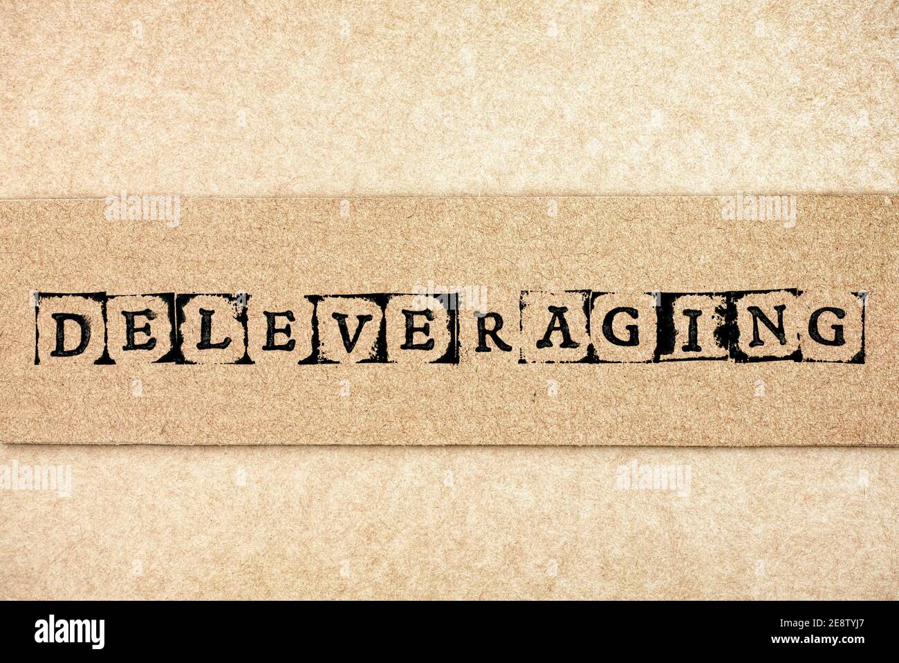 Cardboard with word Deleveraging made by black alphabet stamps Stock ...