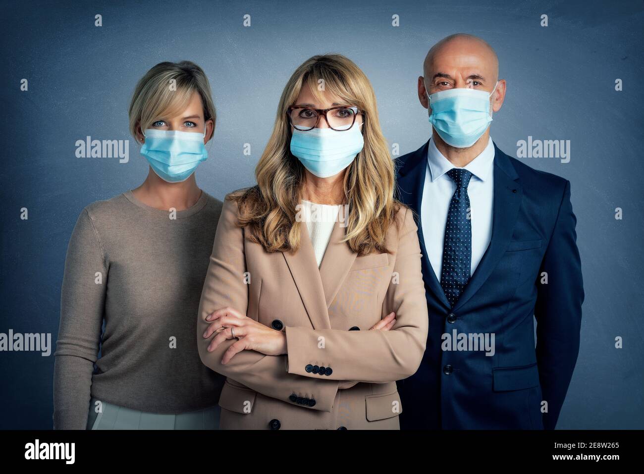 Group of business persons wearing face masks while standing side by ...