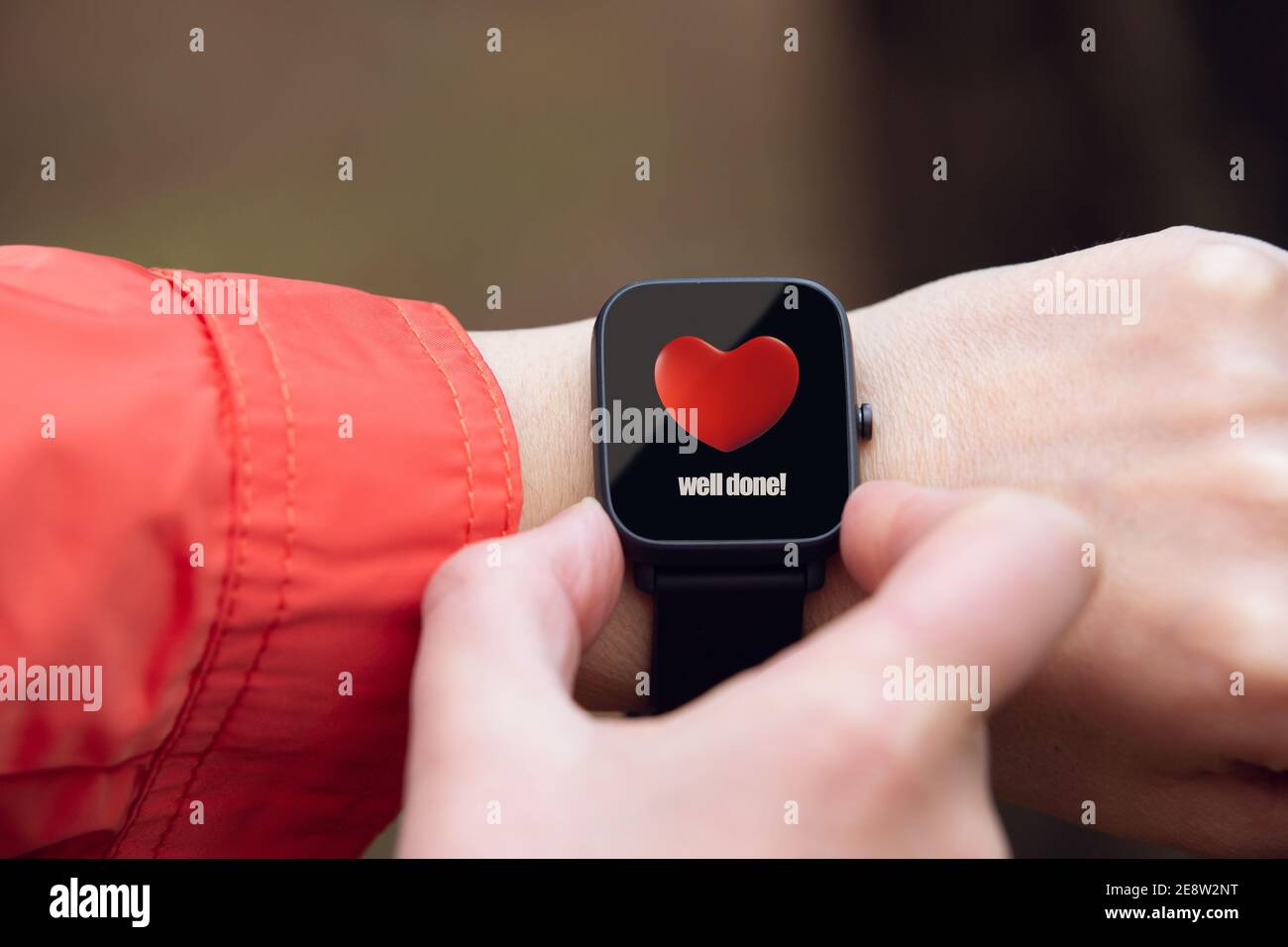 smart watch worn on the wrist seen up close with the symbol of a heart ...