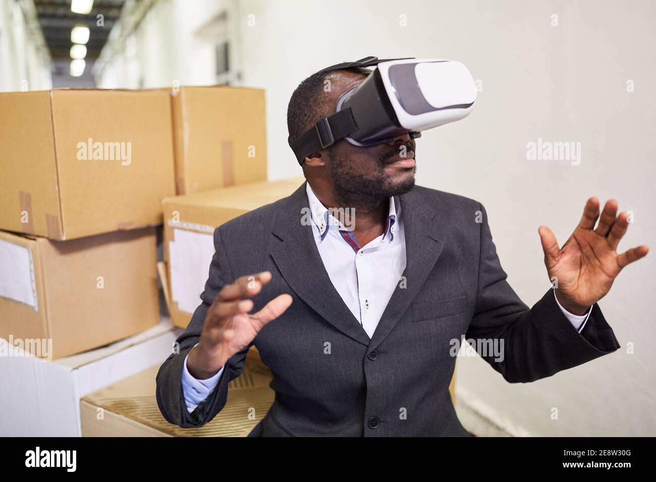 Manager in a factory with VR glasses to simulate the VR working world ...