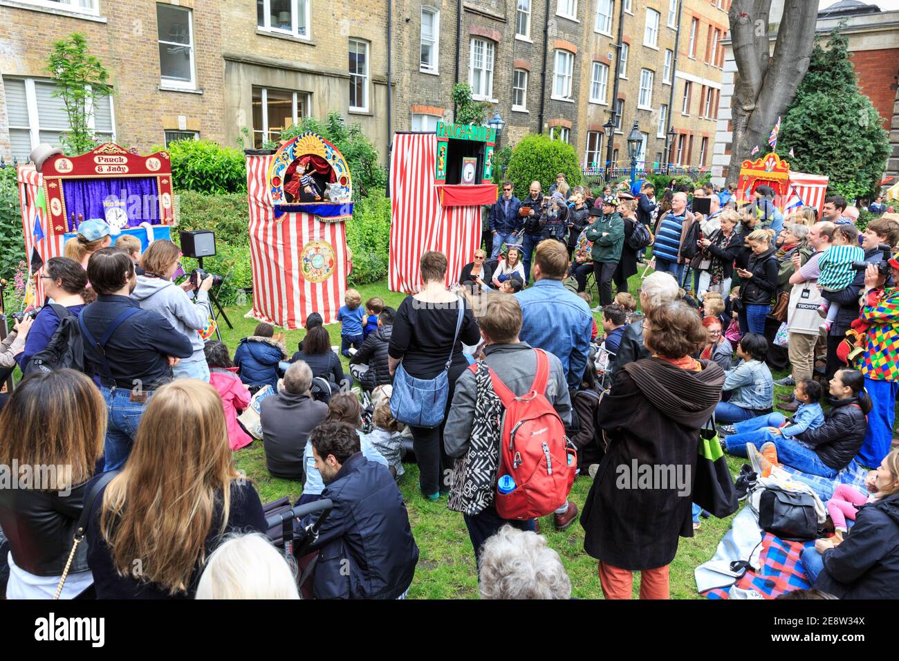 People watch a Punch and Judy show at the Covent Garden May Fayre and ...