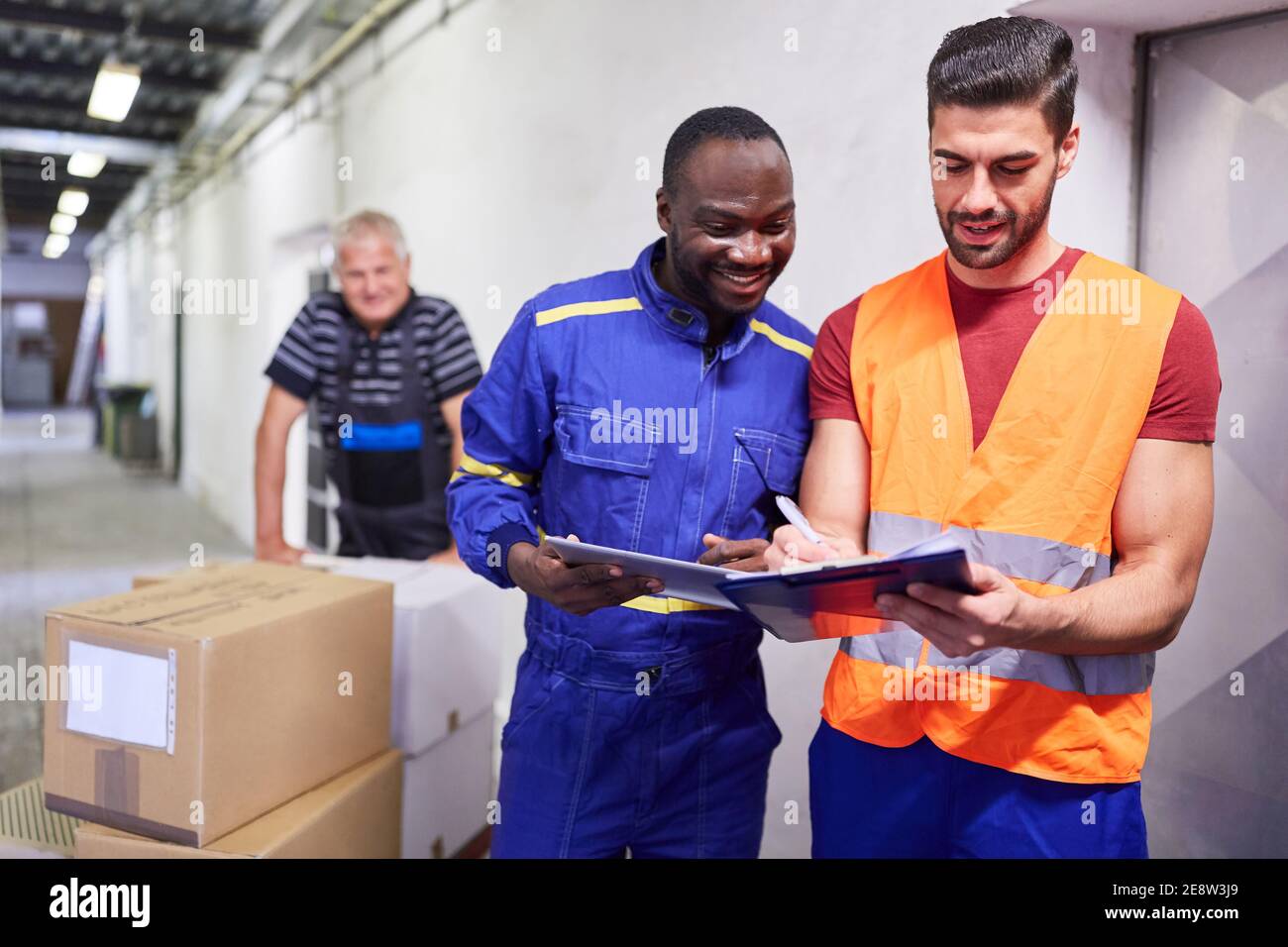 Incoming warehouse clerk checks package delivery with checklist on ...