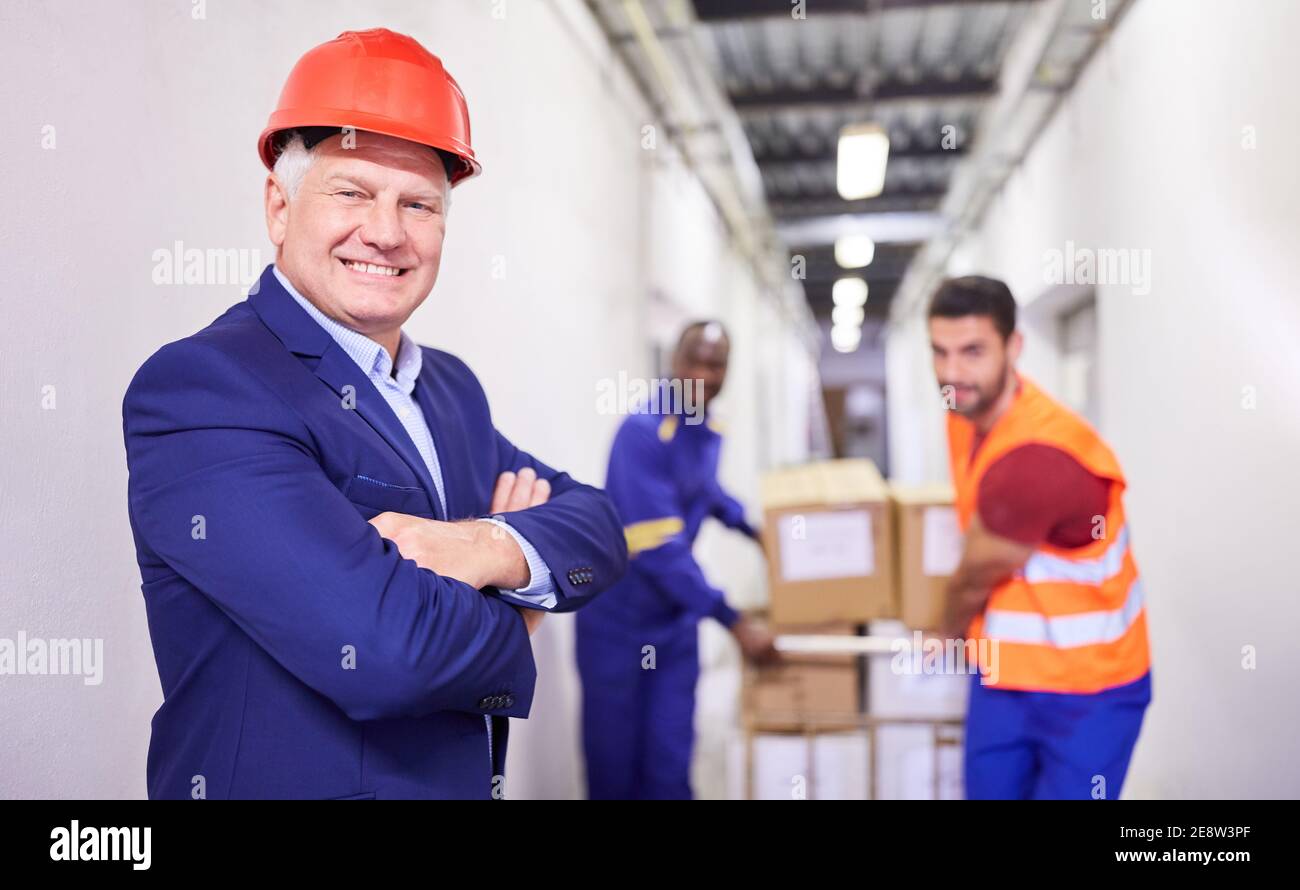 Self-confident entrepreneur as the boss of a haulage company in front ...