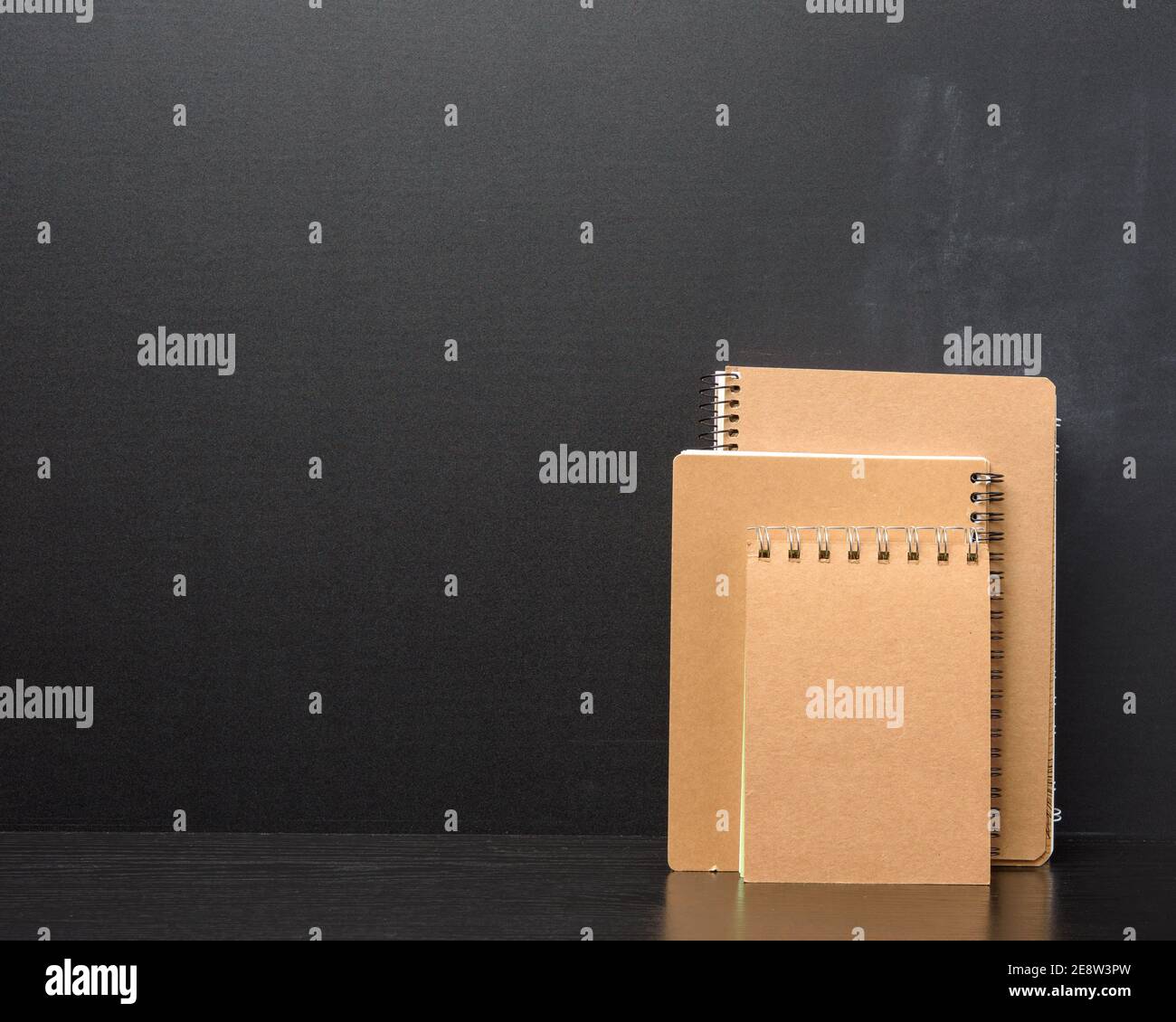 closed notepad with brown sheets on black background, copy space Stock Photo - Alamy