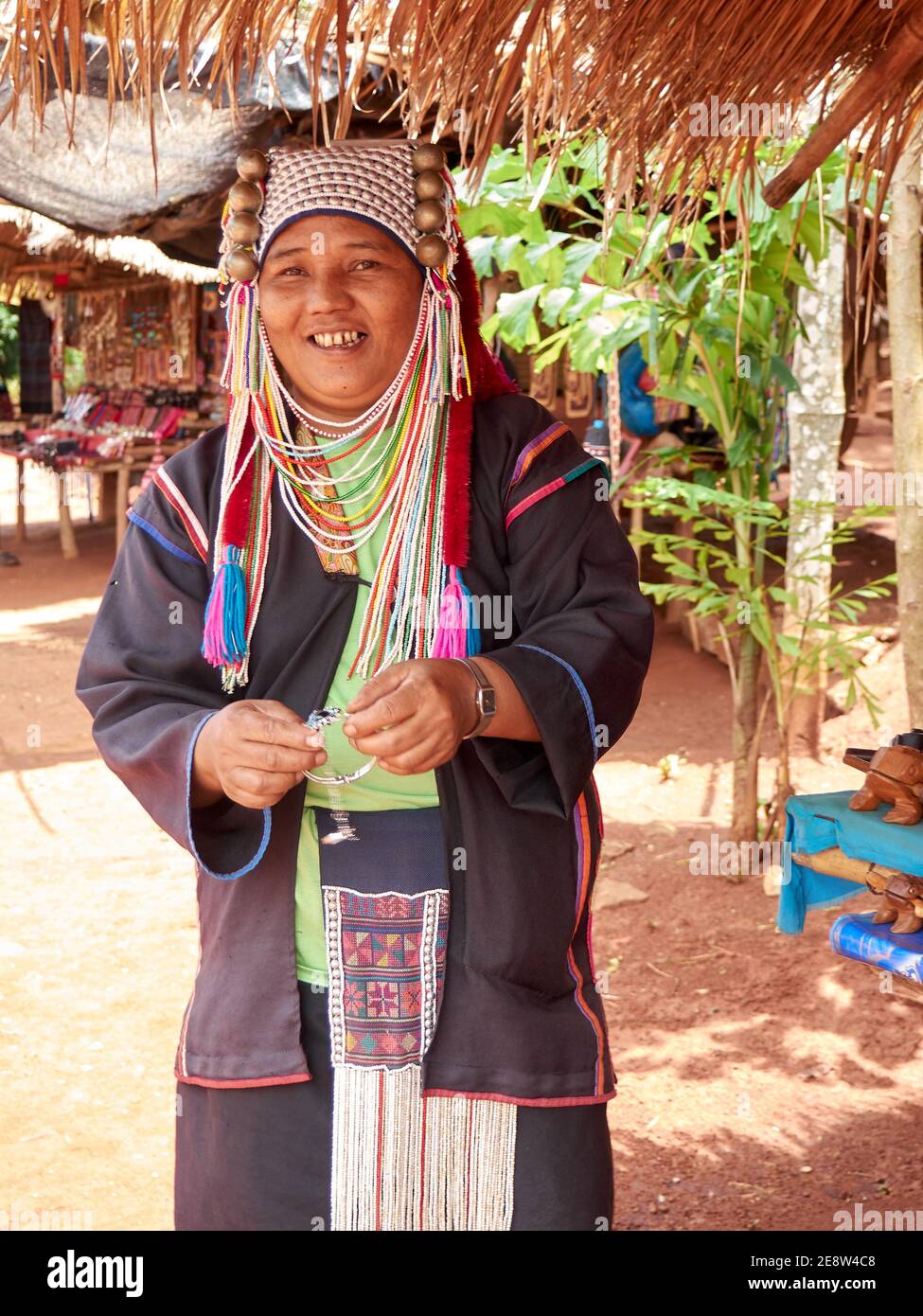 A portrait of a laughing Akha hill tribe woman in her signature dress ...