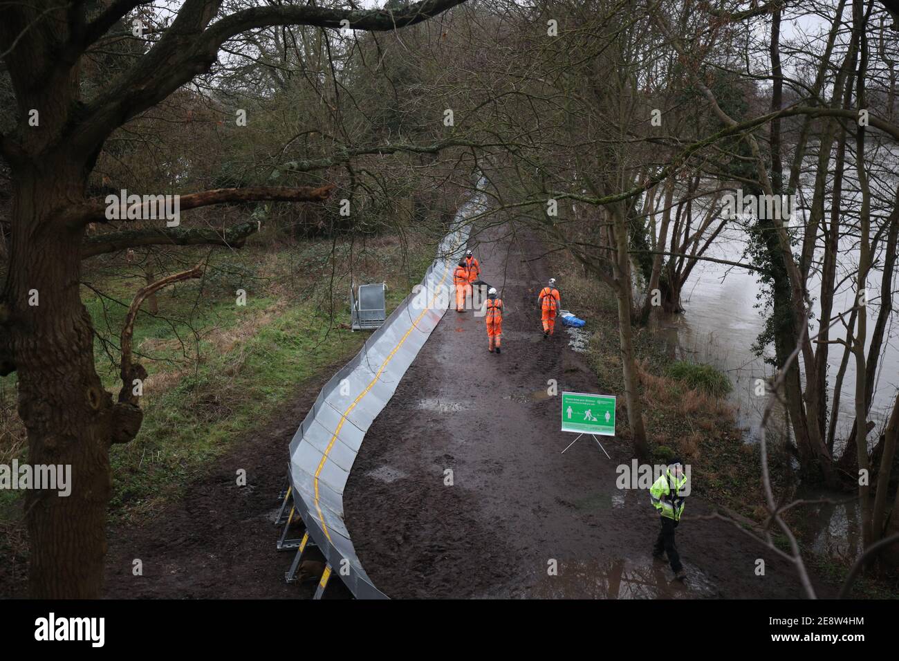 Workers at the temporary barrier in Weybridge, Surrey, after Storm ...