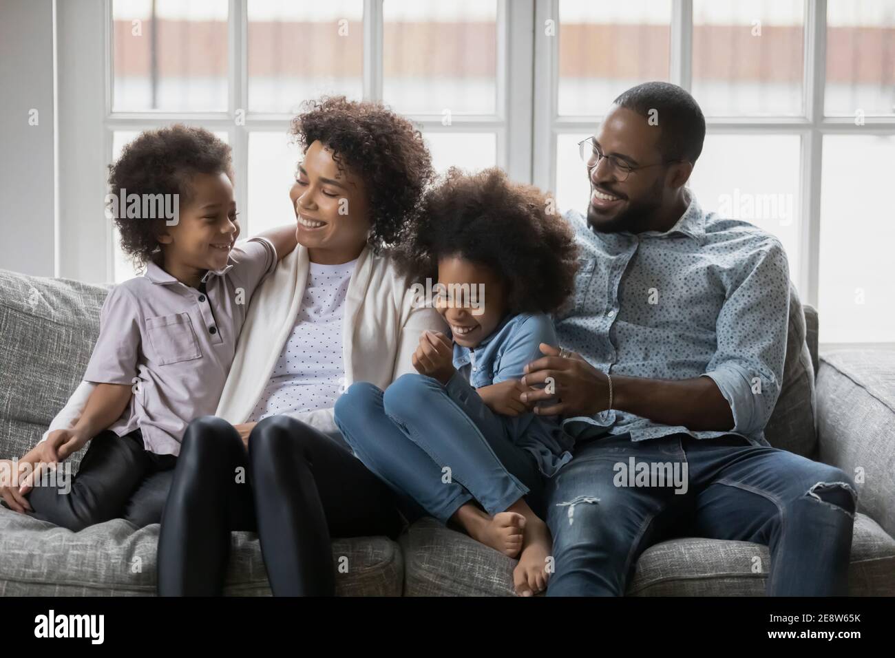 Close up happy African American family relaxing on cozy couch Stock ...