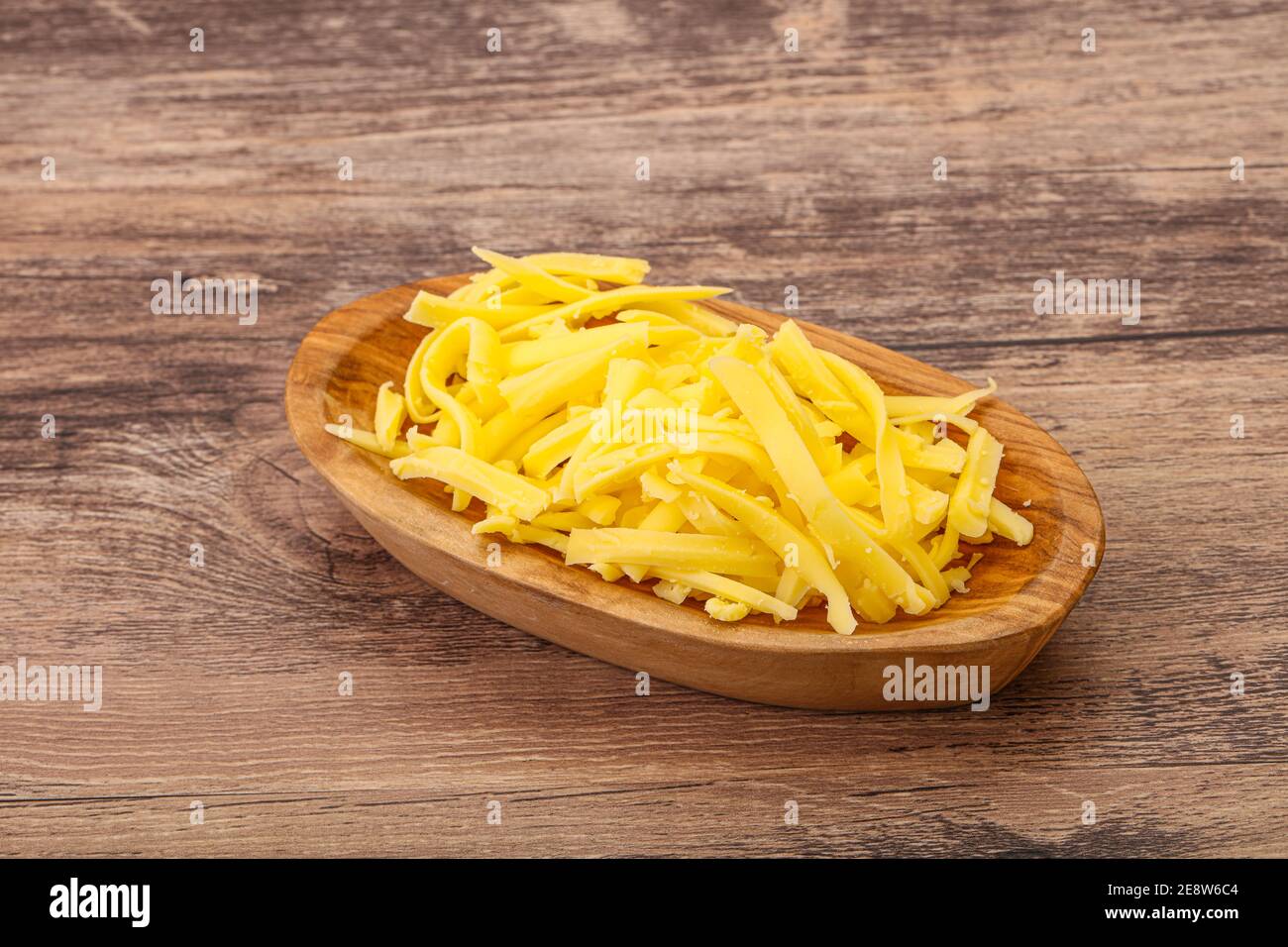 Shredded yellow cheese in the bowl for cooking Stock Photo - Alamy