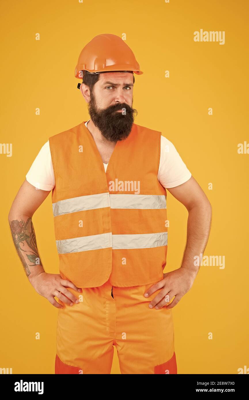 Man in construction. Working man yellow background. Bearded man in hard ...