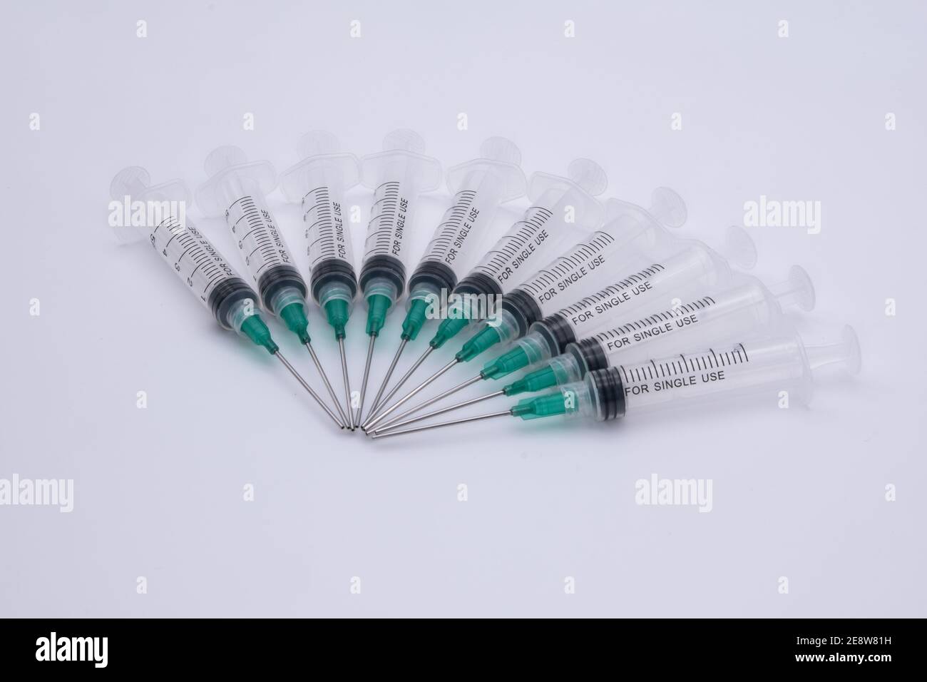 clear plastic syringes with needles isolated against a white background ...