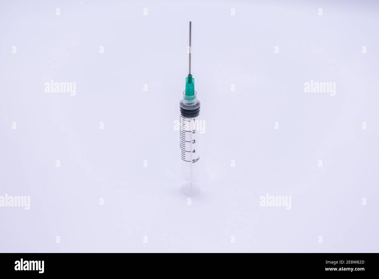 Clear syringe isolated against white background Stock Photo - Alamy