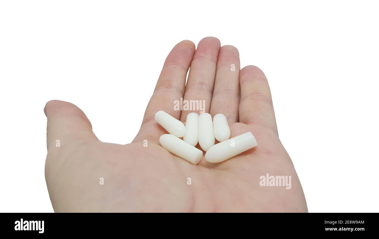 Hand holding rectal suppositories on white background Stock Photo - Alamy