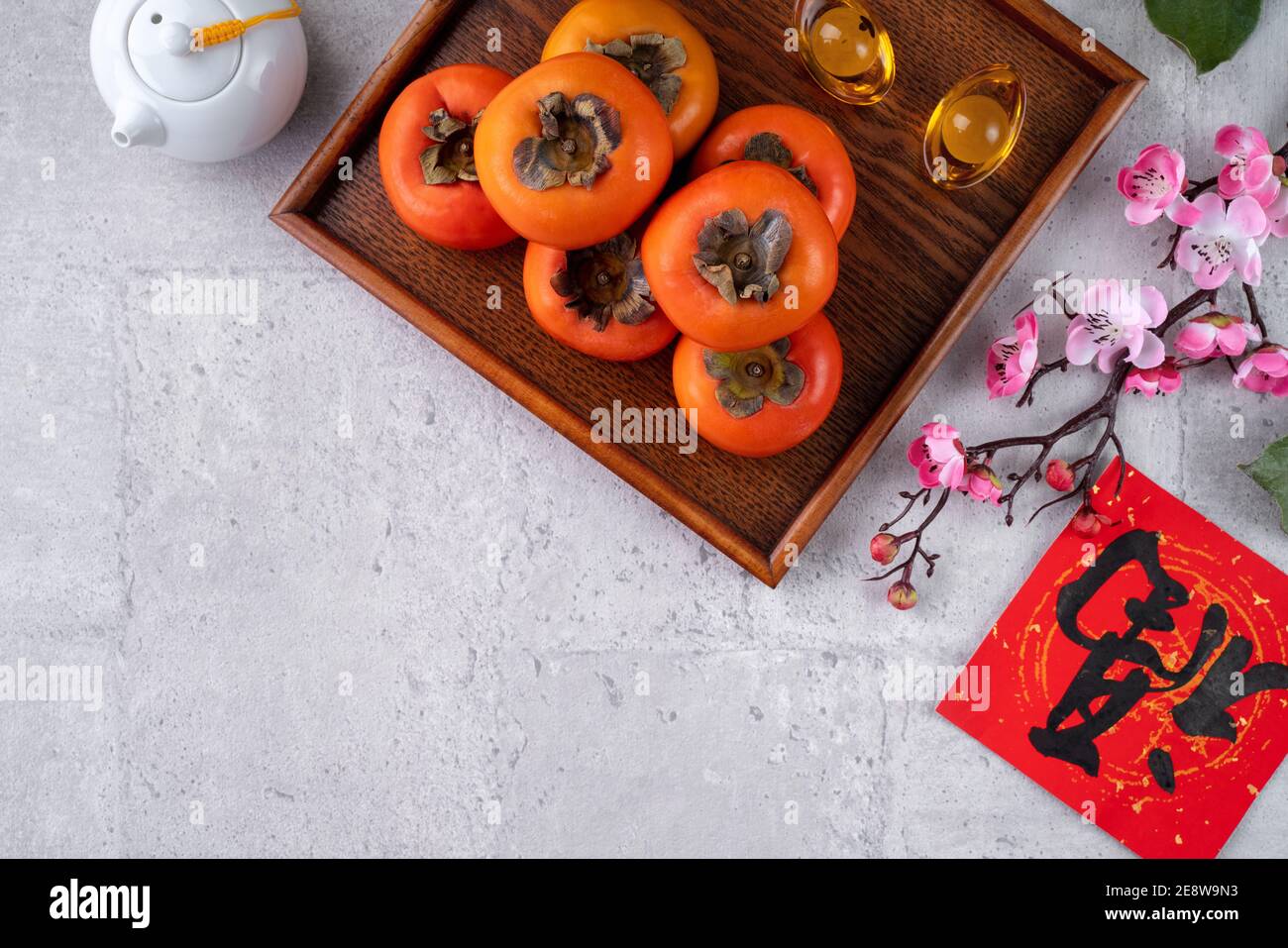 Fresh persimmons on gray table background for Chinese new year fruit ...