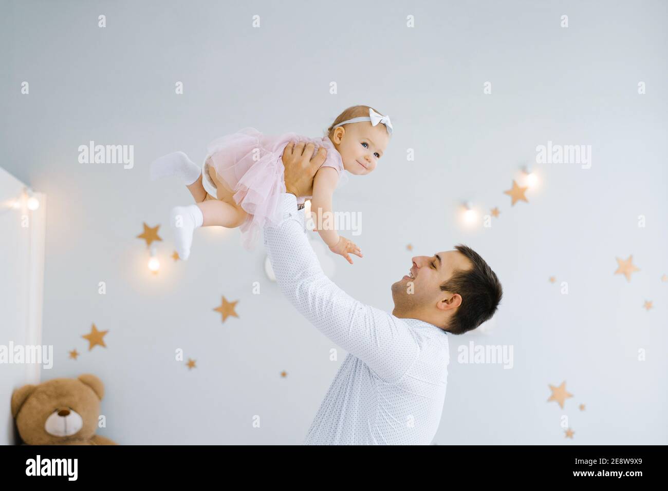 Father lifting baby girl. Happy father picks up and throws his lifting ...