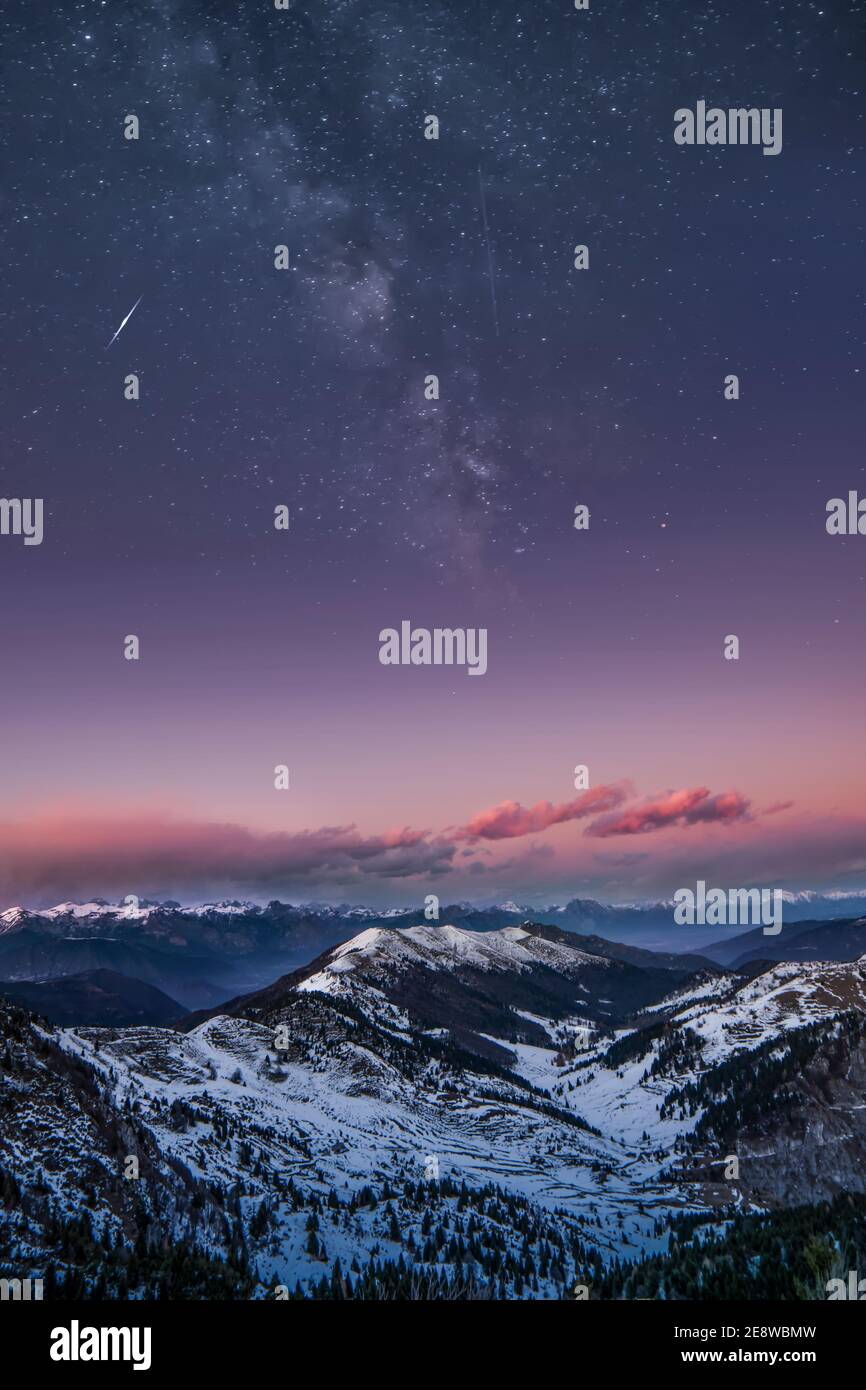 Milky Way Galaxy glowing in the purple sky Stock Photo - Alamy