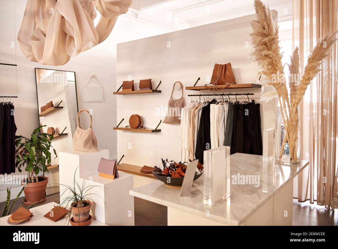 Interior of stylish clothing shop with accessories on display Stock ...