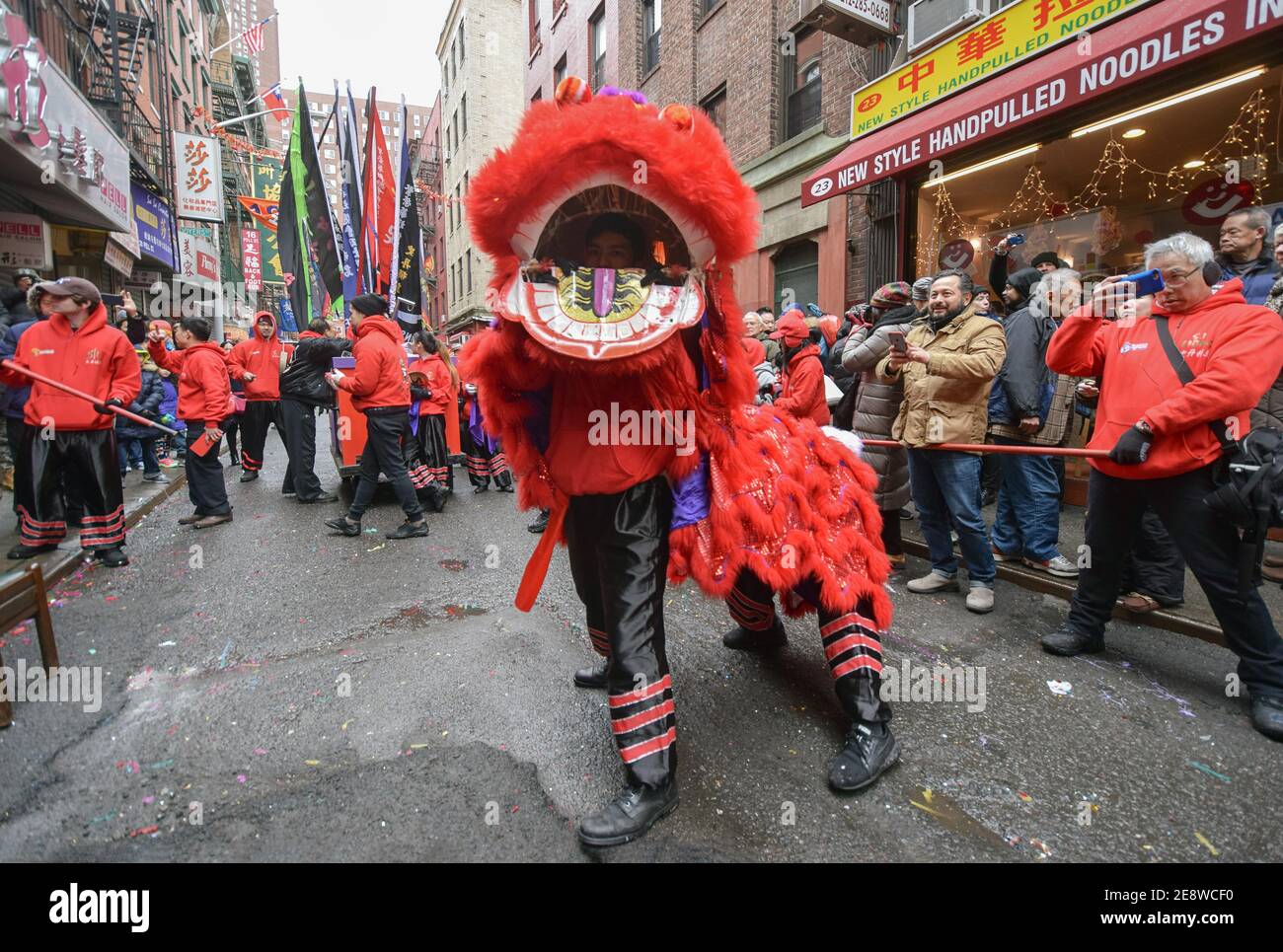 A dragon dance outside a restaurant on Pell Street in Chinatown in New ...